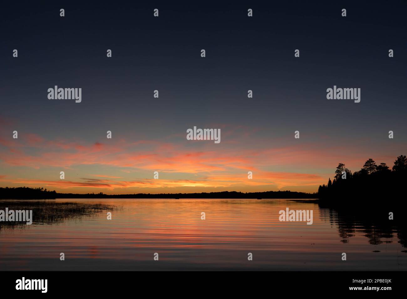 Fading sunset glow at dusk over northern lake scene for magazine ...