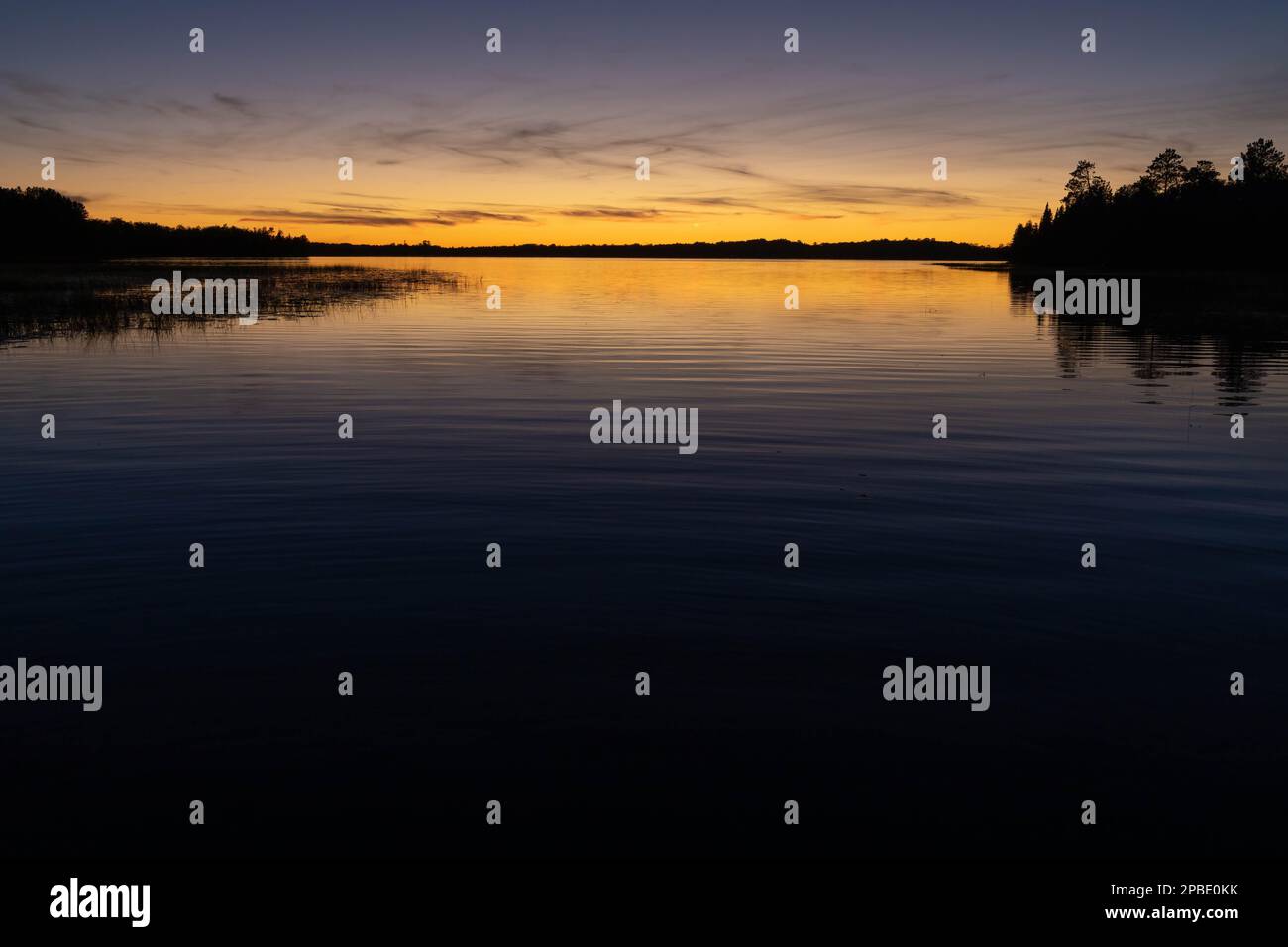 Fading sunset glow at dusk over northern lake scene for magazine ...