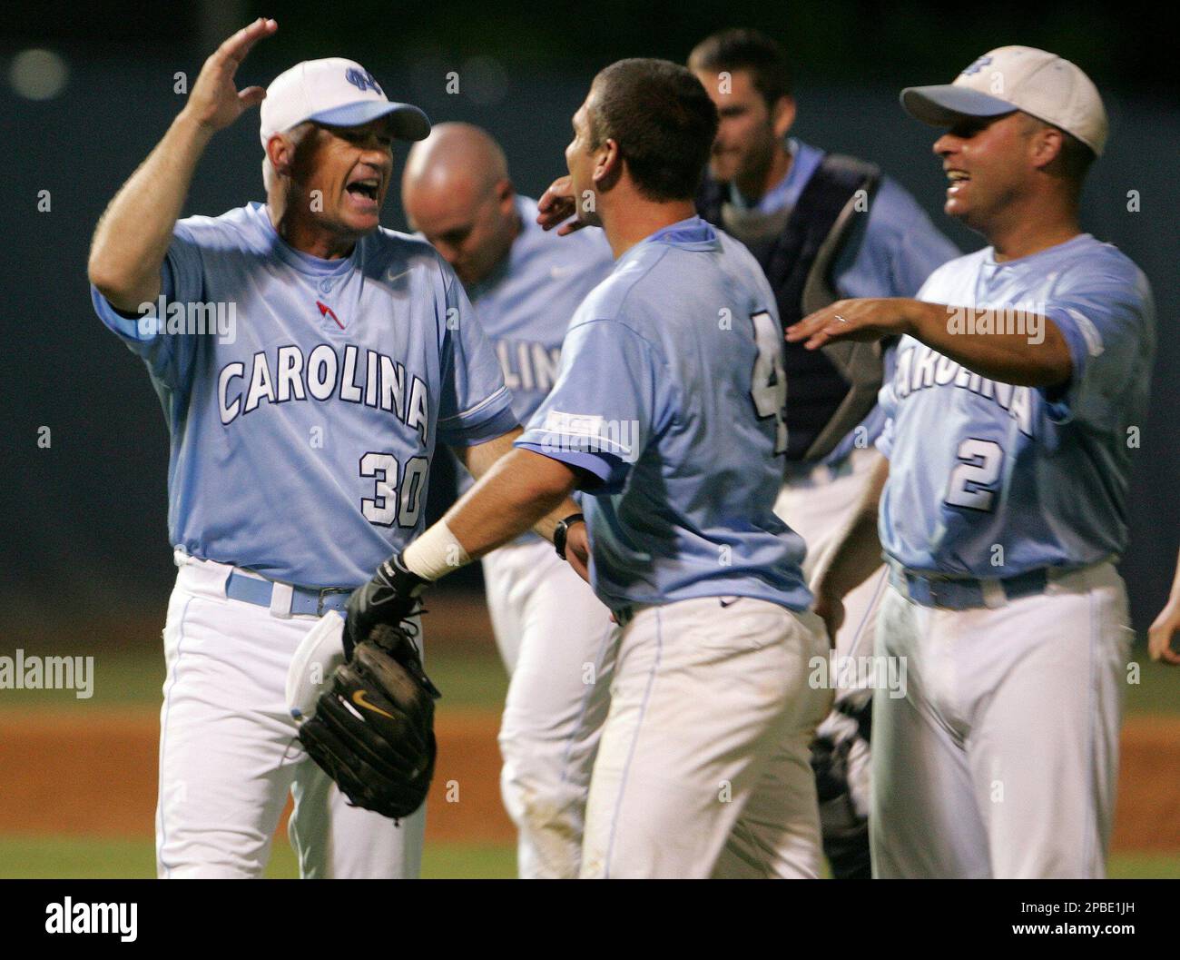 North Carolina coach Mike Fox (30) celebrates with Garrett Gore, center ...