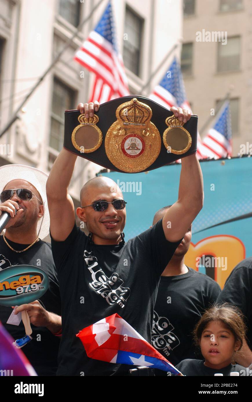 Puerto Rican boxer Miguel Cotto holds up his WBA Welterweight champion ...