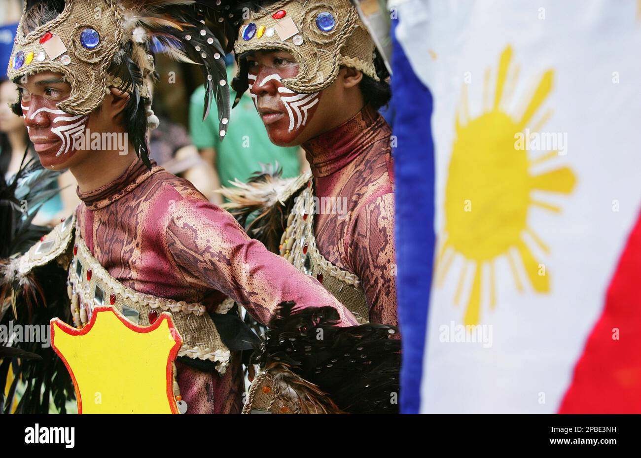 Filipino performers in colorful costumes dance as part of celebrations ...