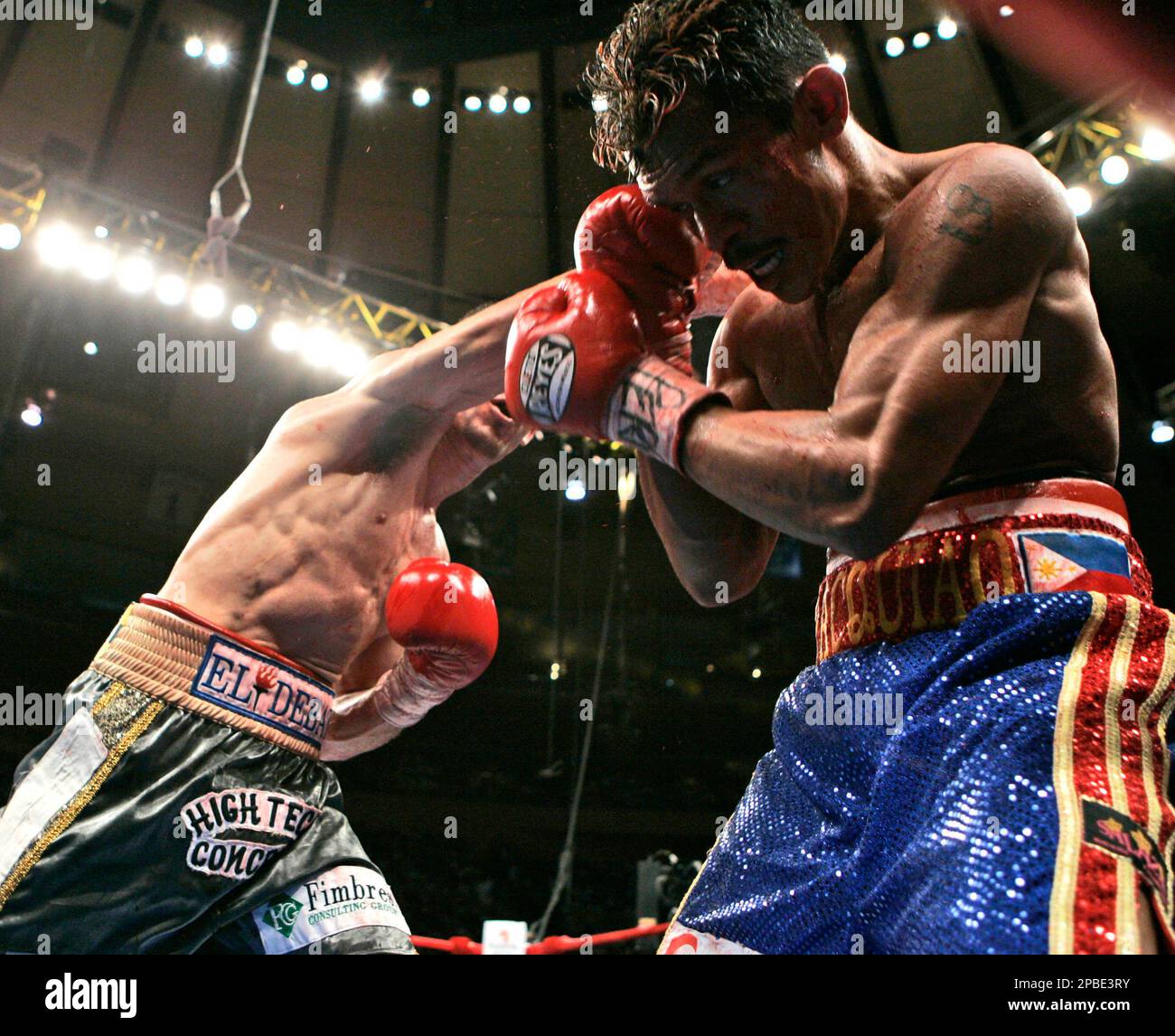 Bobby Pacquiao, of the Philippines, braces for a punch from Humberto ...