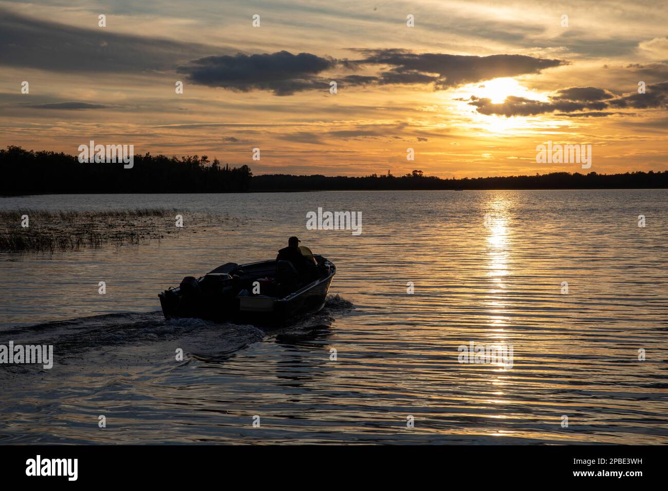 Boating at Sunset on a Minnesota Fishing Lake Stock Photo - Alamy