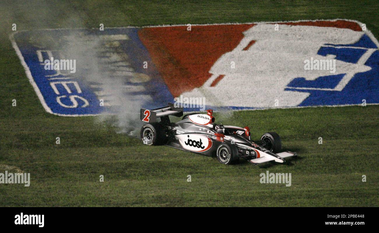 Tomas Scheckter of South Africa slides across the front oval after ...