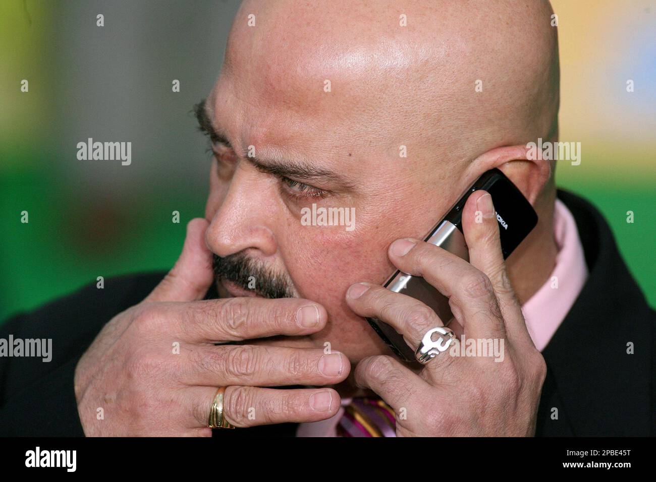 Bollywood director Rakesh Roshan talks on the cell phone as he arrives ...