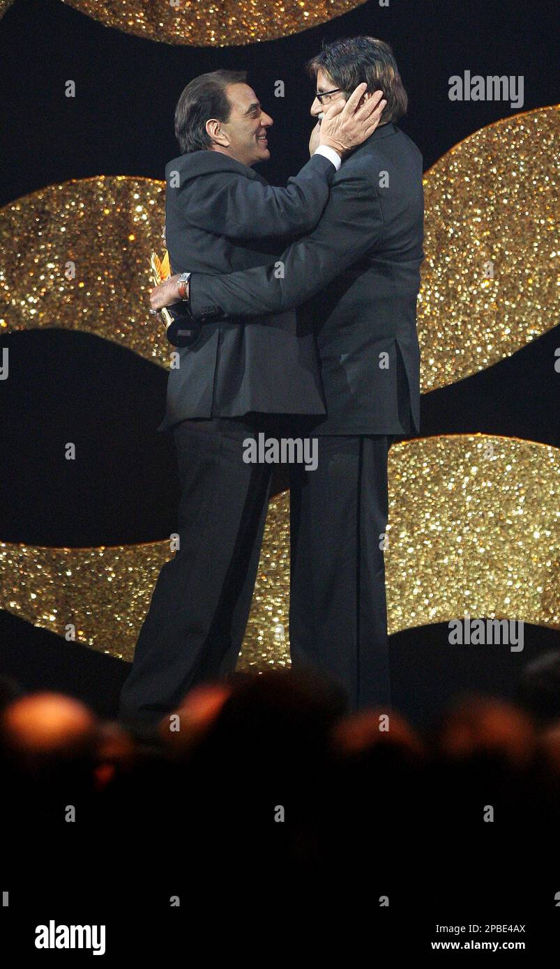 Bollywood veteran Dharmendra, left, and actor Amitabh Bachchan embrace ...