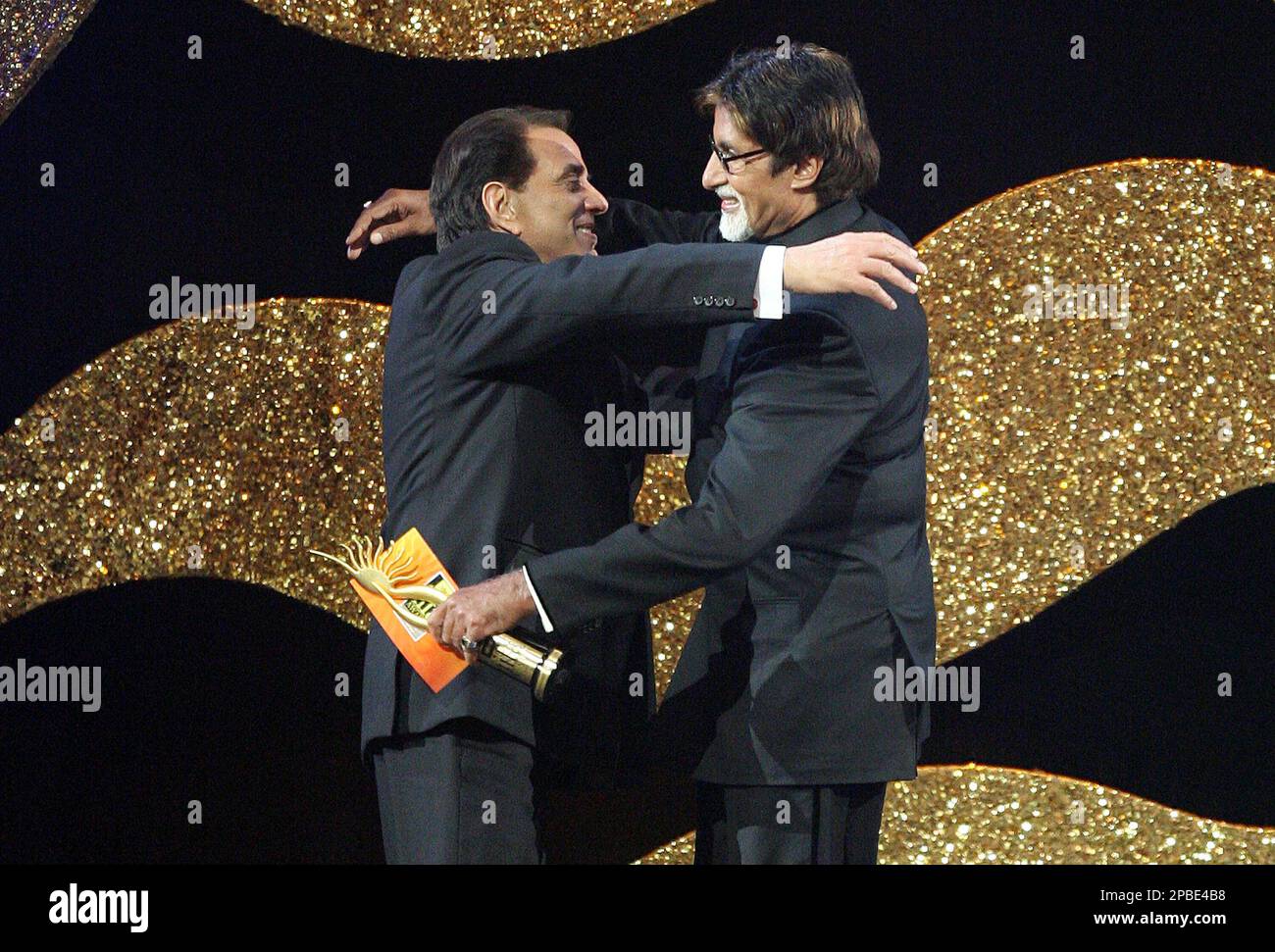 Bollywood veteran Dharmendra, left, and actor Amitabh Bachchan embrace ...