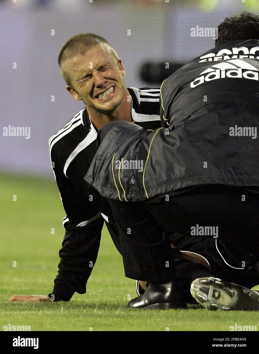 Real Madrid's David Beckham, from England, grimaces as a team doctor ...