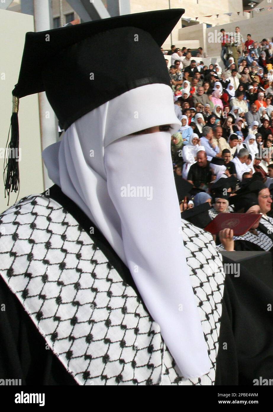 A veiled Palestinian student waits to receive her diploma at a ...