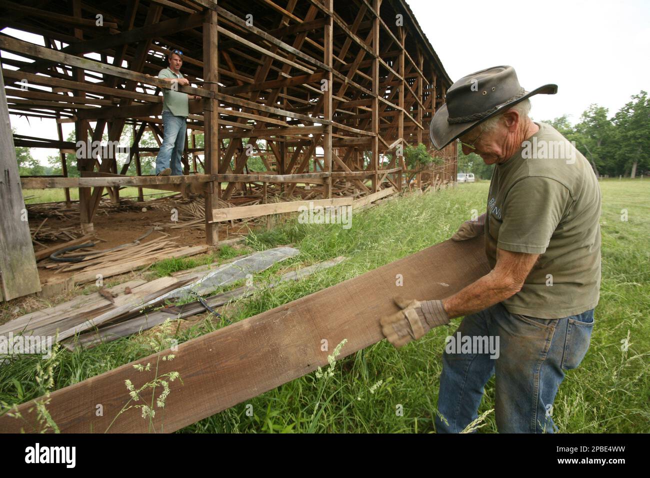 David Odor, right, and George Gatewood removed a piece of siding from a ...
