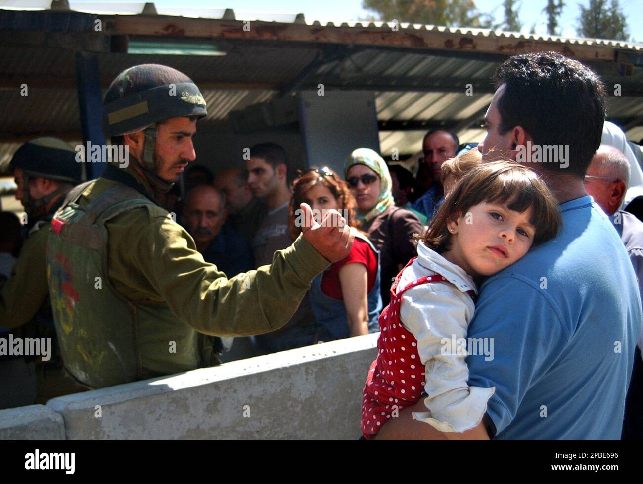 Palestinians wait to cross the Israeli army's Beit Iba checkpoint near ...