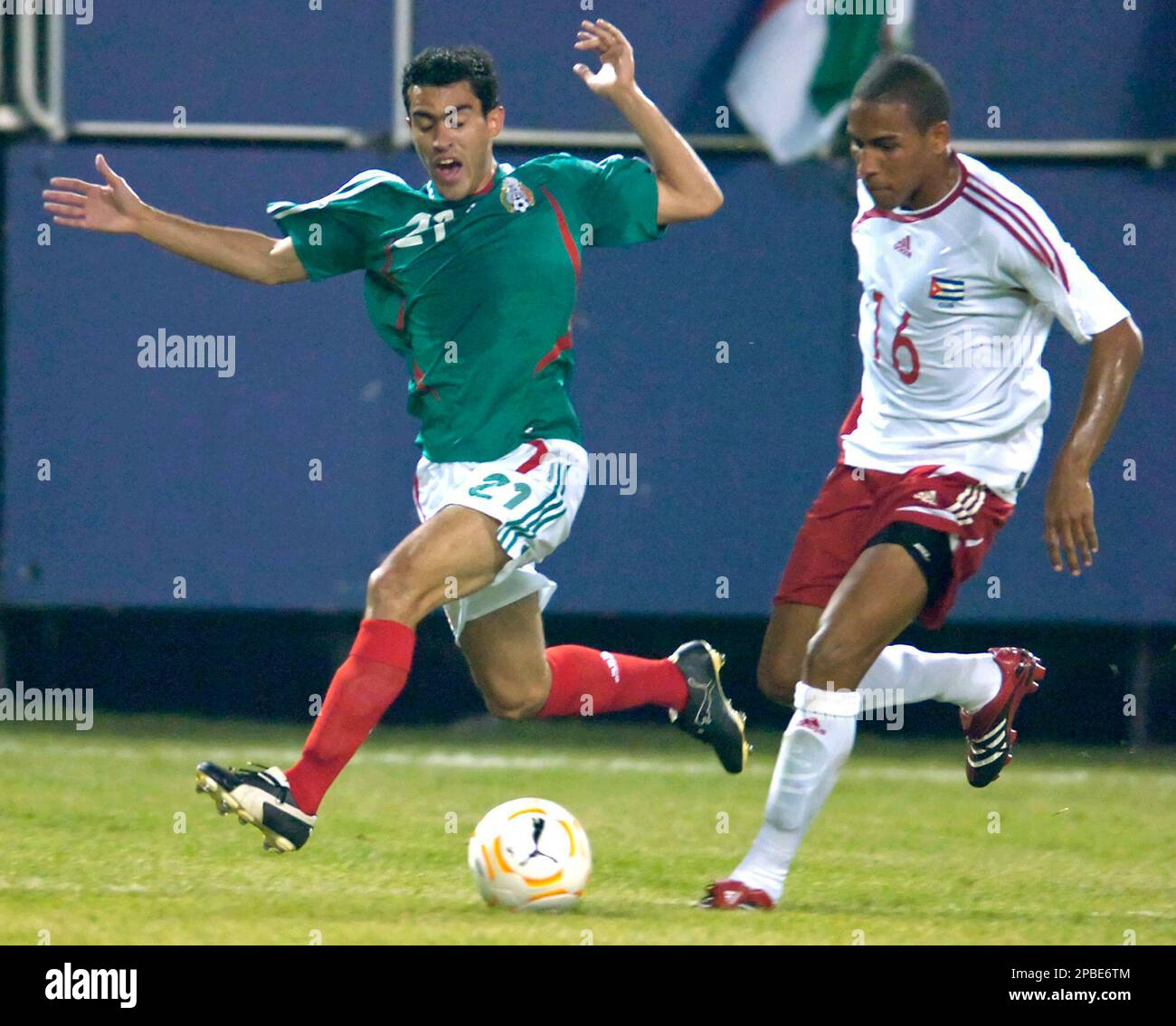 Mexico's Nery Castillo, left, is bumped off the ball by Cuba's ...