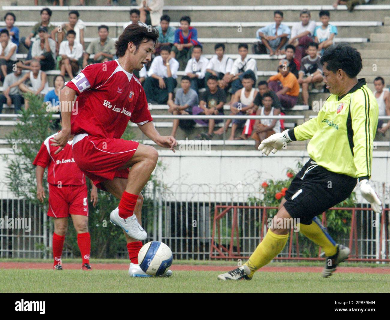 Japanese soccer star Hidetoshi Nakata, left, challenges an unidentified ...