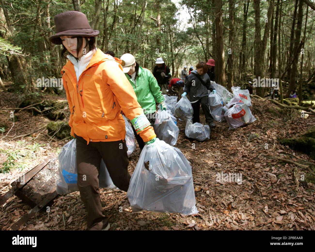 Mayumi Wakamura, who heads periodic clean-ups of the mountain, leads ...