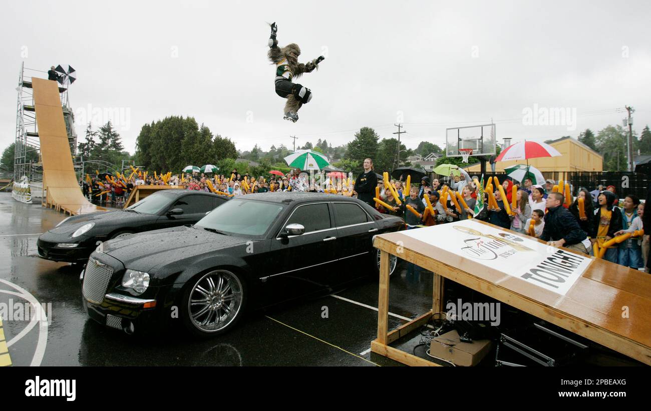 Squatch, the Seattle SuperSonics mascot, makes a ramp jump on in-line ...