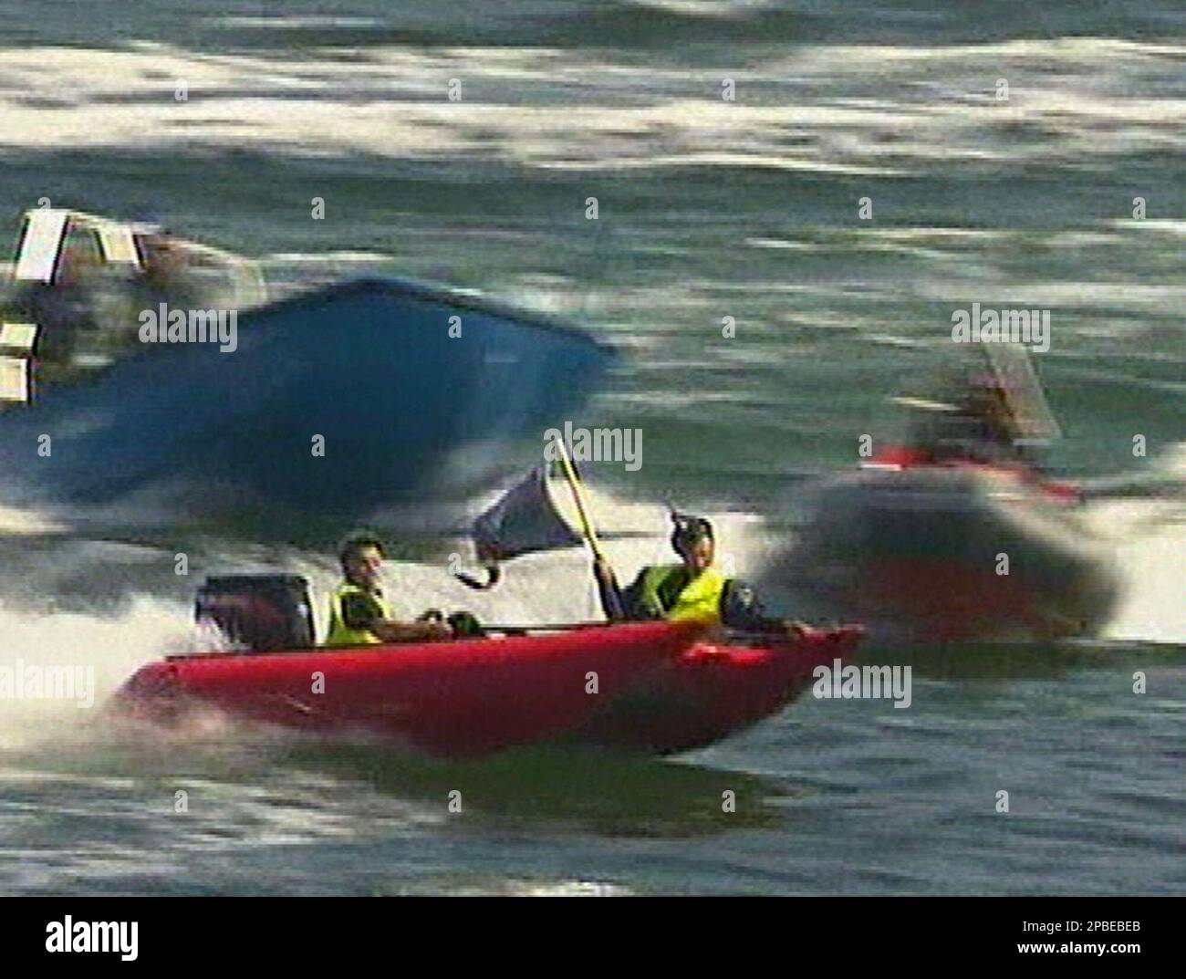 German police boats, background, pursue Greenpeace activists, front, in ...