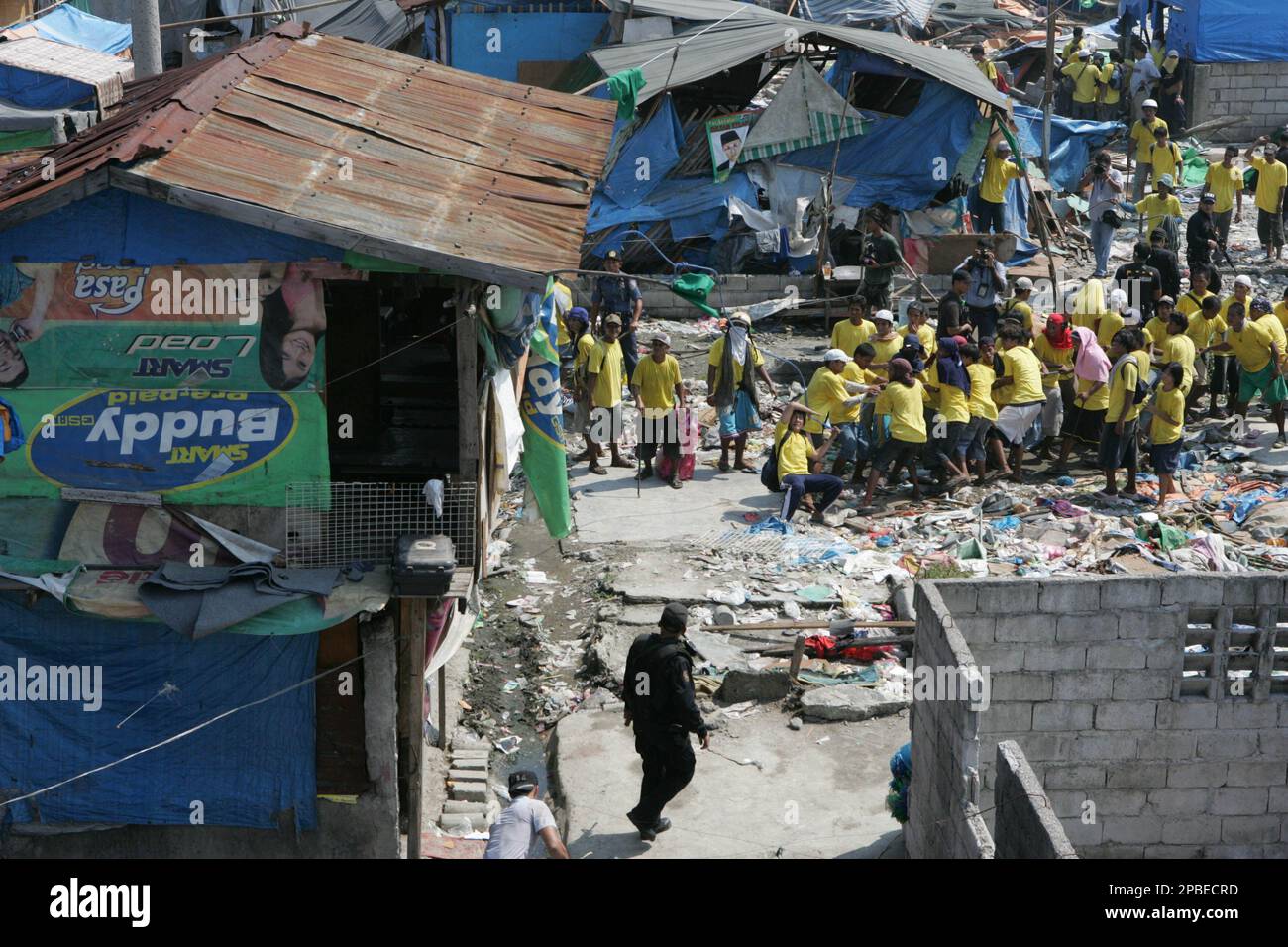 Demolition crew tear down squatter shanties at a reclamation site in ...