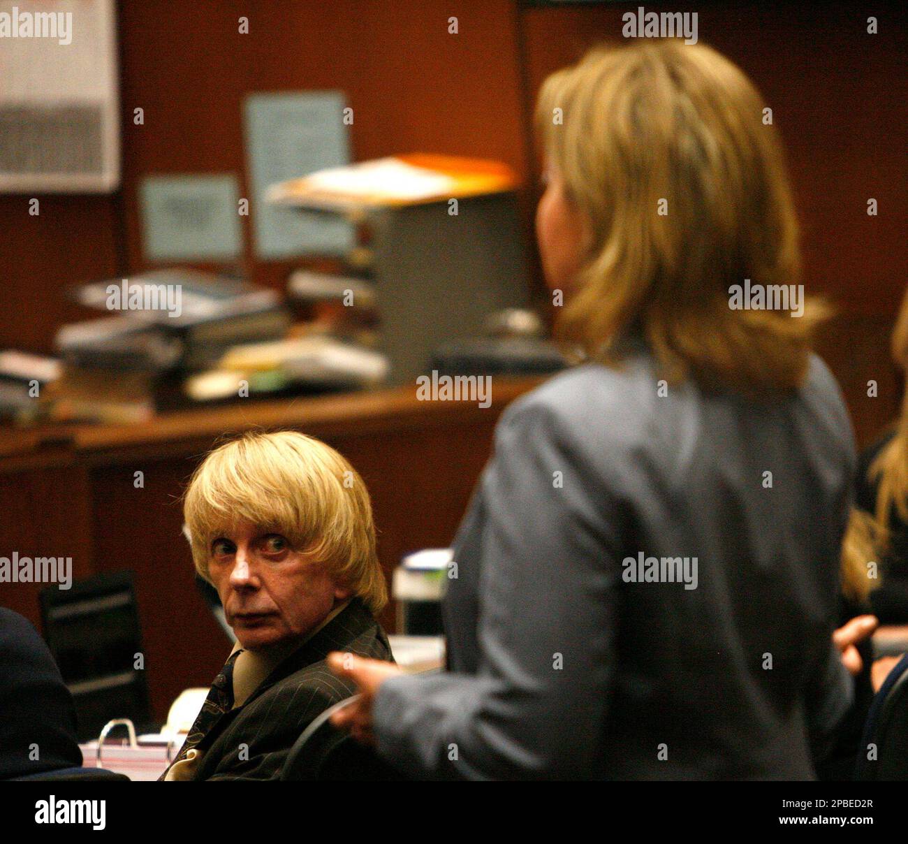 Music producer Phil Spector, left, looks at his former defense attorney ...