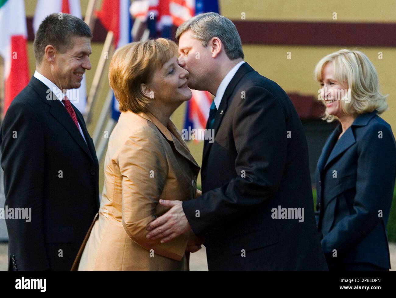 Canadian Prime Minister Stephen Harper, center right, kisses German ...