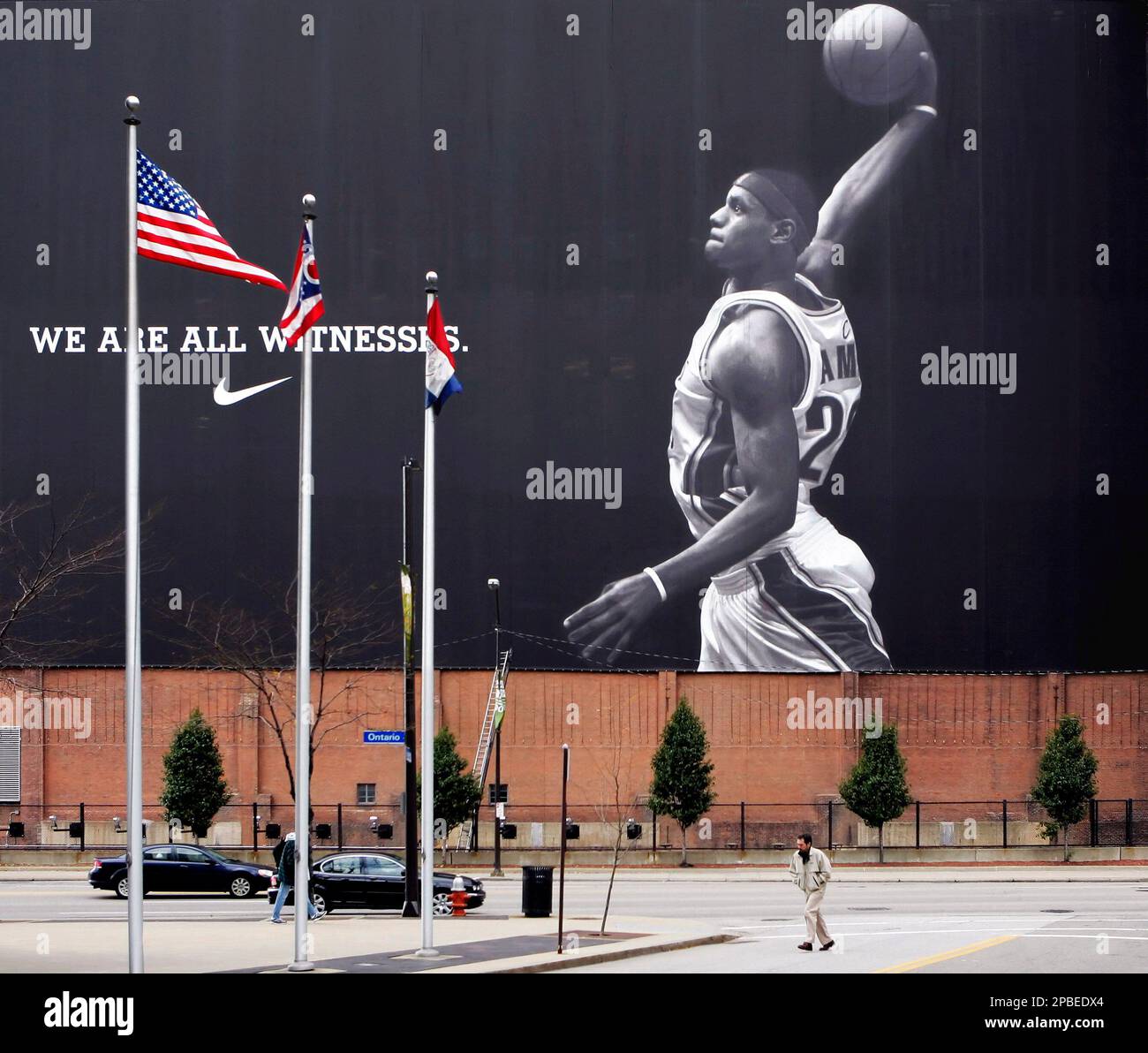 ** FILE ** A man crosses the street in front of a large banner ...
