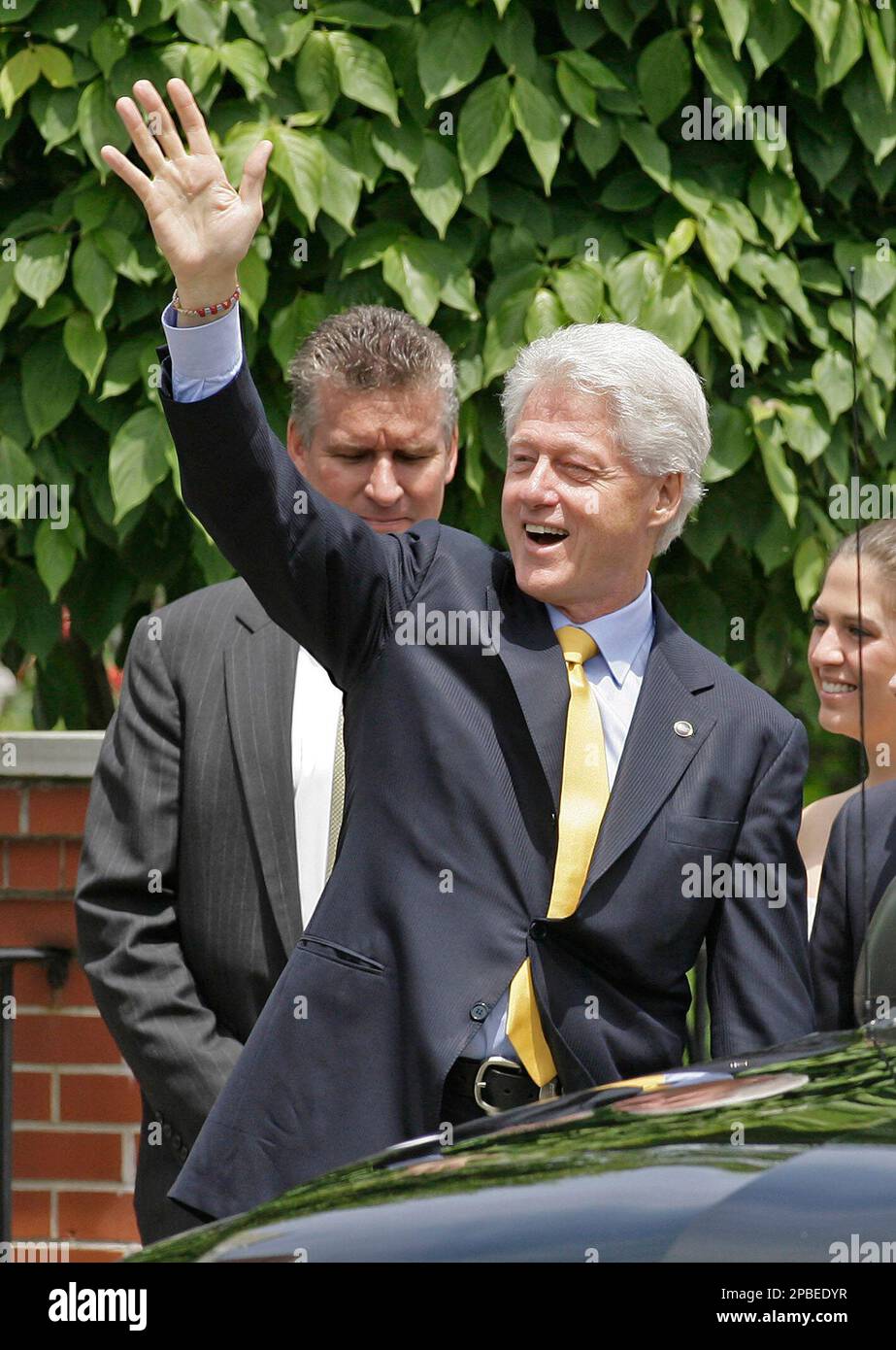 Former President Bill Clinton waves to supporters as he leaves a ...