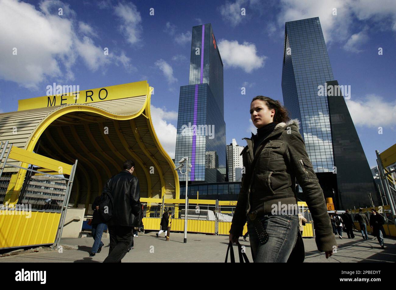 A girl walks in front of the towering office of Nationale Nederlanden ...