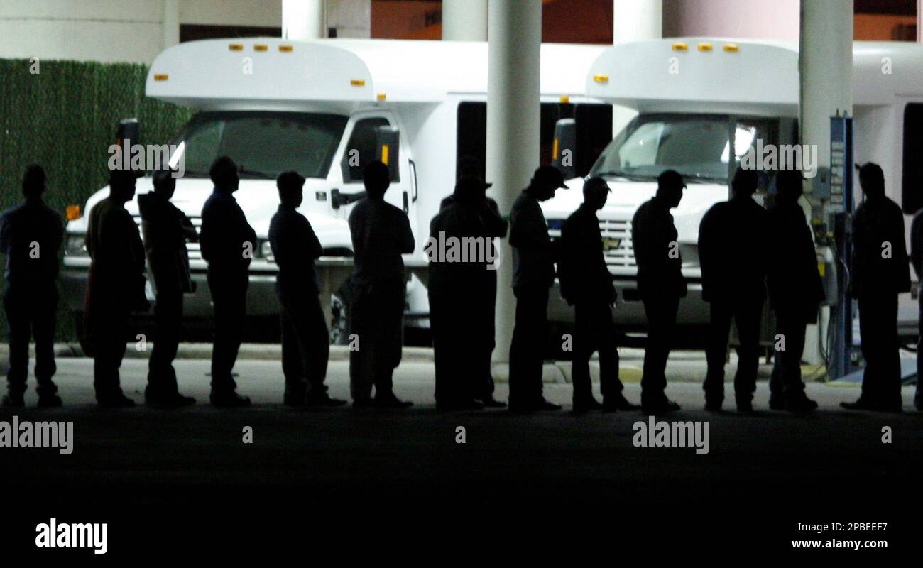 People planning to enter the country line up for processing by U.S ...