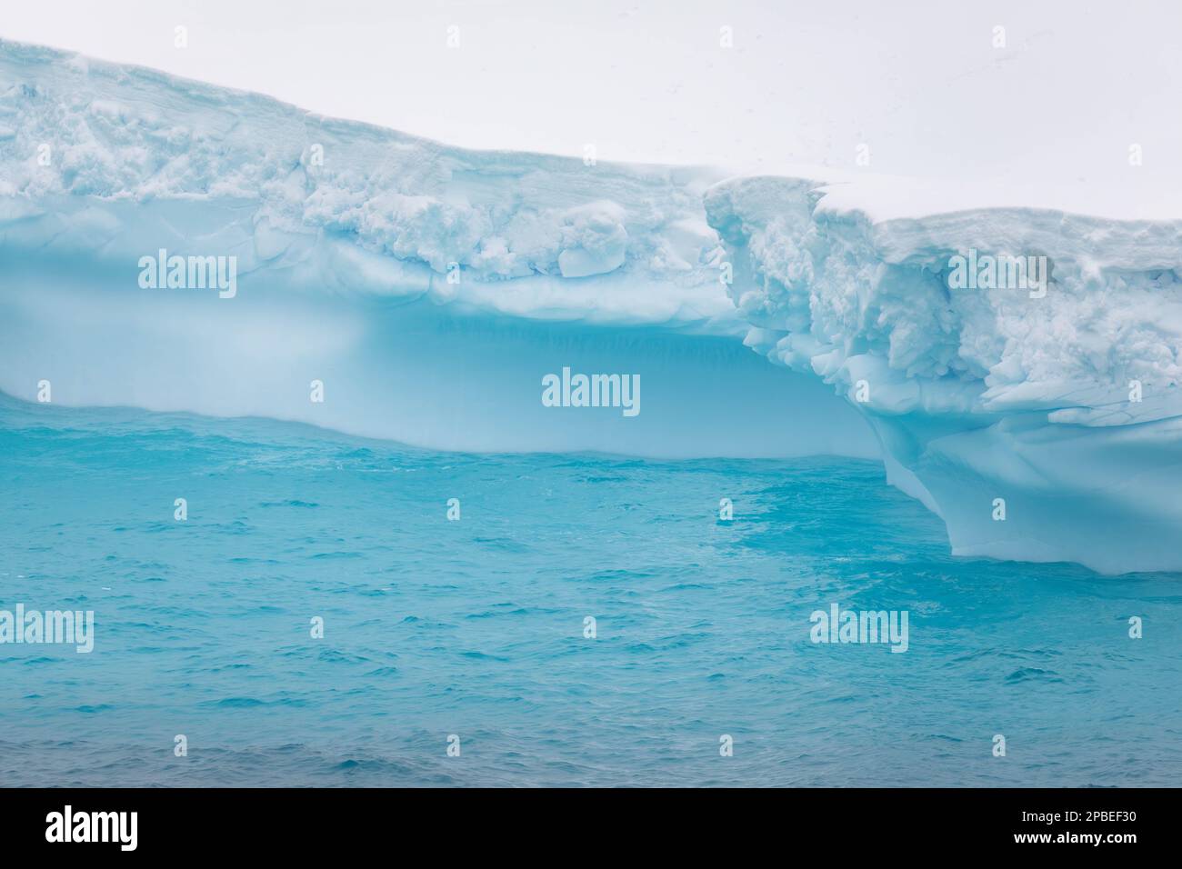 Beautiful shades of blue from a melting iceberg glacier floating in ...