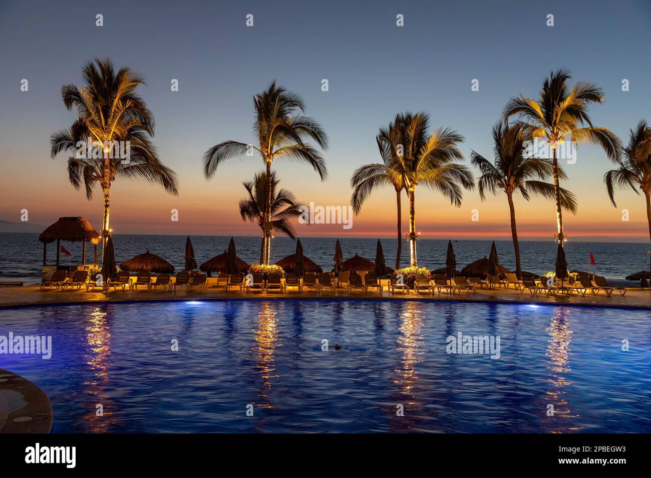 Tropical Beach Sunset with Beautiful Swimming Pool Stock Photo - Alamy