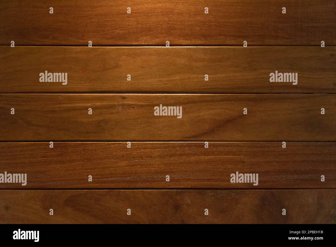 Wood wall texture under downlight provides rich color background ...