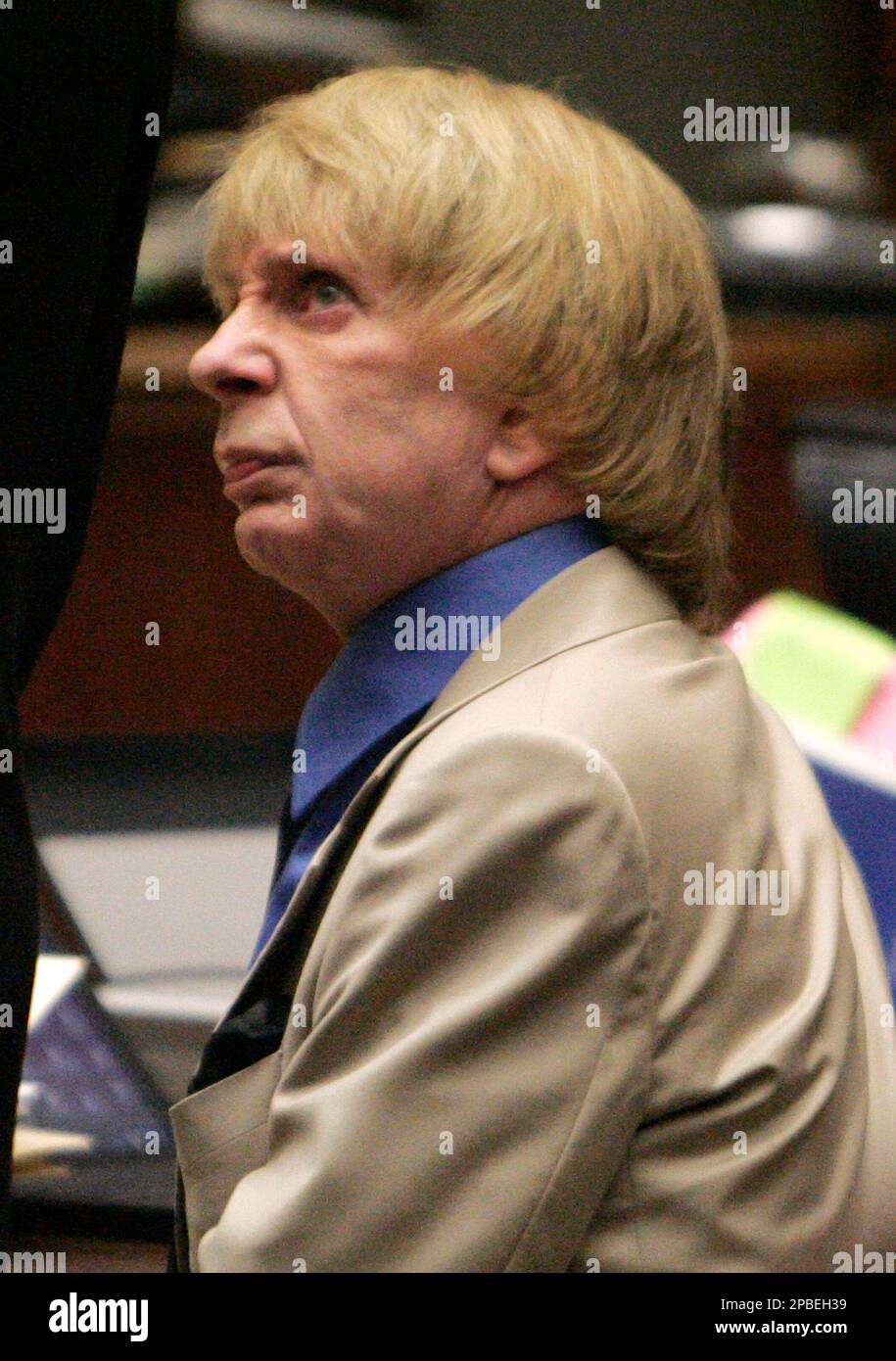 Music producer Phil Spector looks up as his defense attorney Bradley ...
