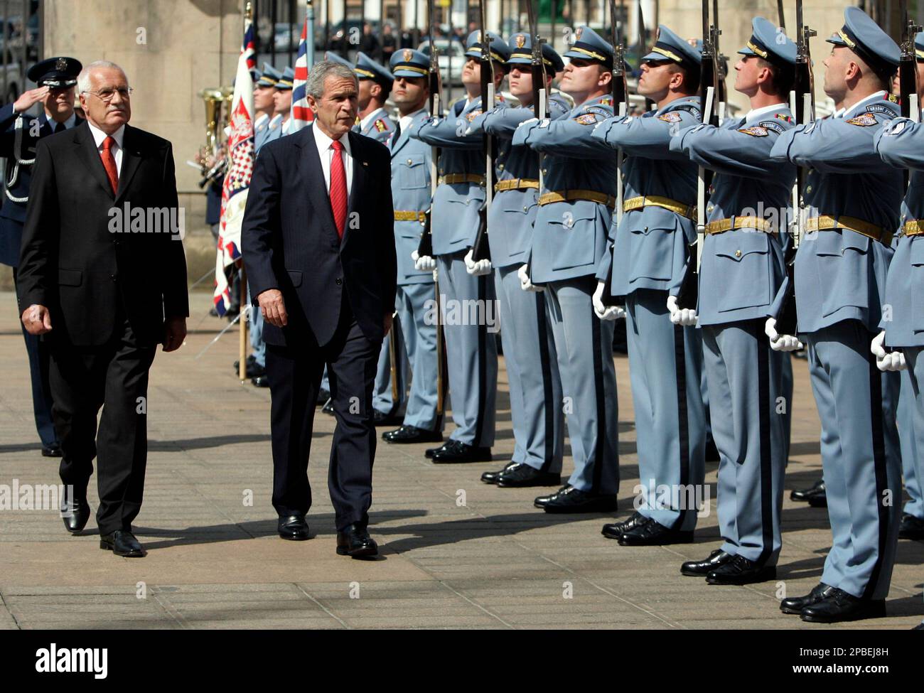 U.S. President George W. Bush, centre, walks with the President of the ...