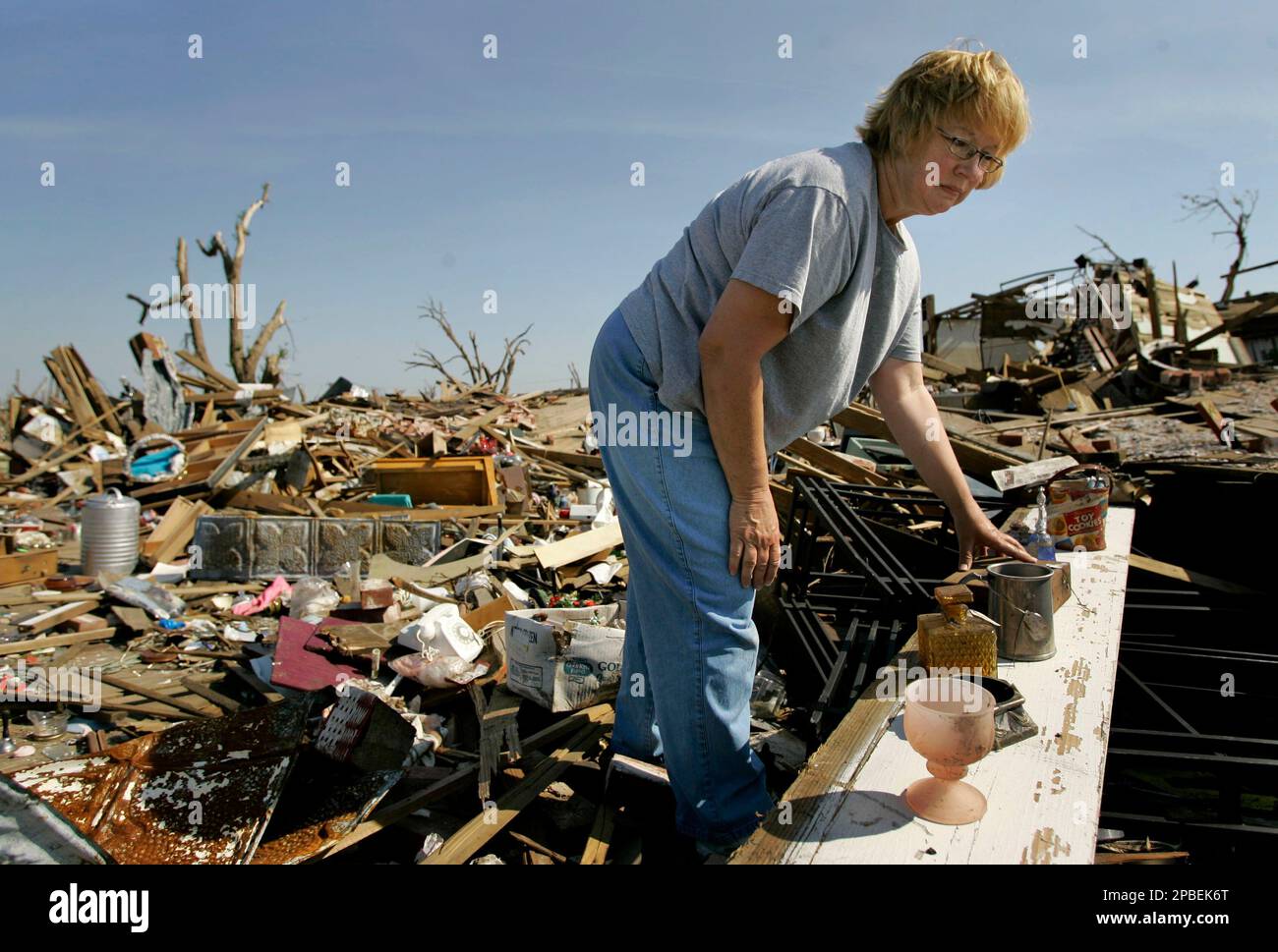 Paula Neier looks for items from her booth in a destroyed antique mall ...
