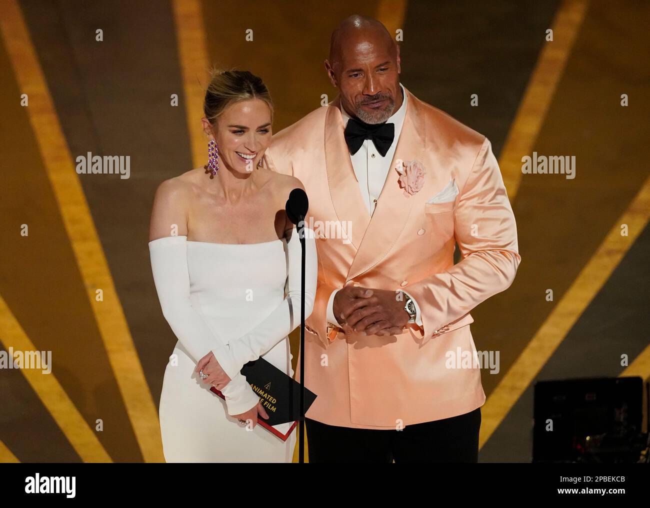 Emily Blunt, left, and Dwayne Johnson present the award for best ...