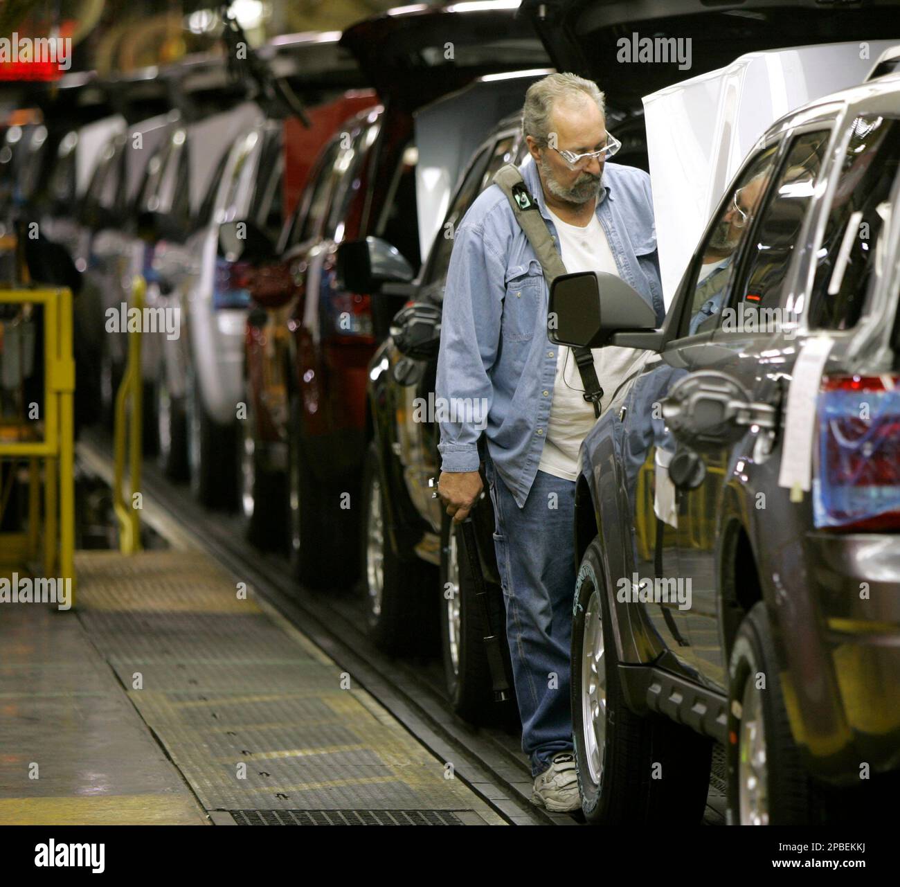 **FILE** An assembly line worker toils on 2008 Ford Escapes and Mercury ...