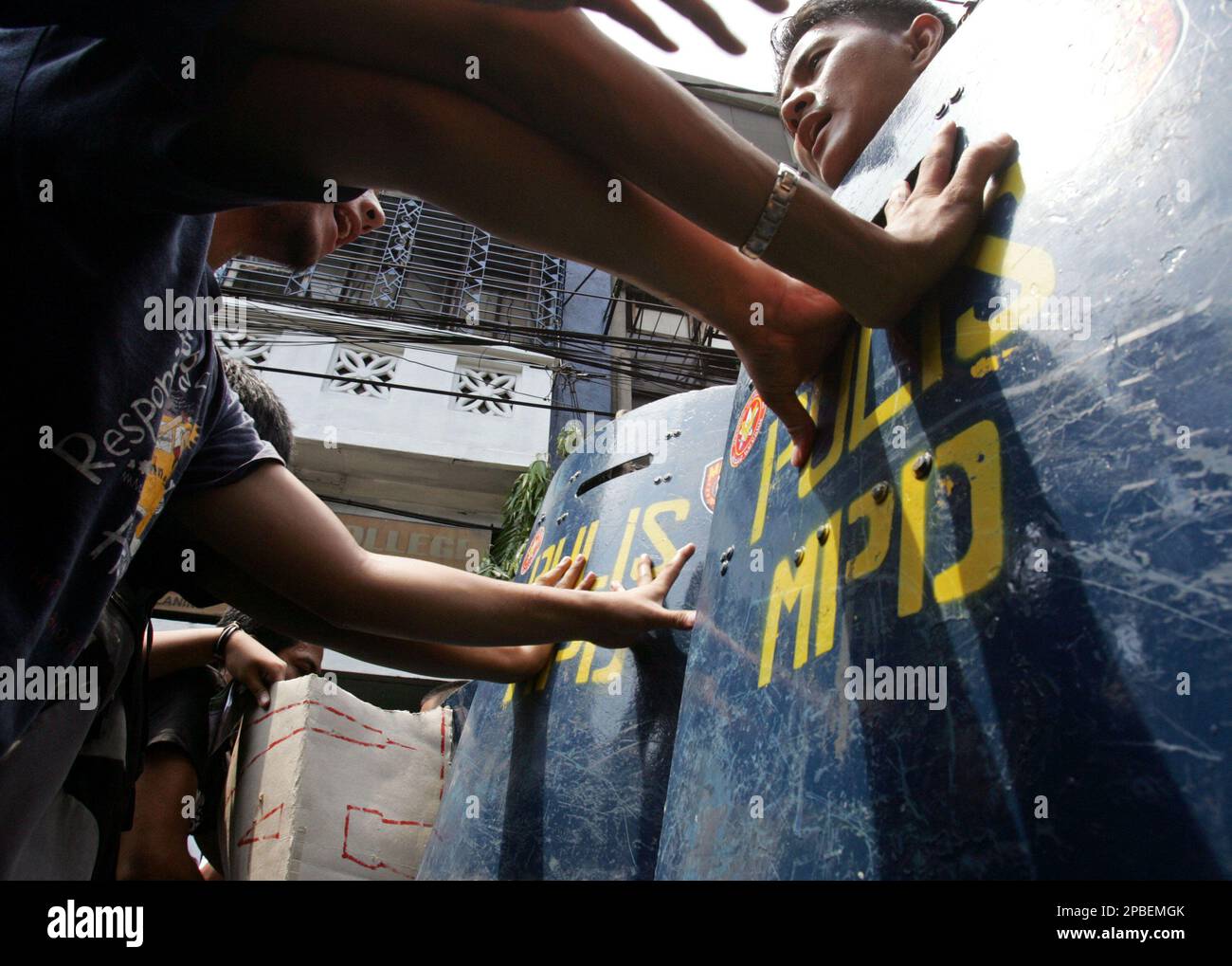 Students try to hold back riot police as they are pushed away after ...