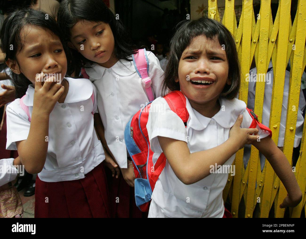 A young Filipino student cries as she looks for her mother during the ...