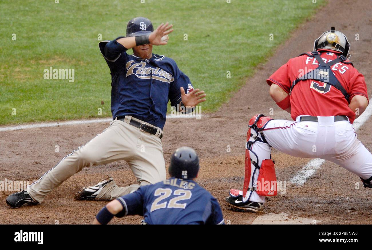 San Diego Padres' Terrmel Sledge, left, slides home to score on a ...