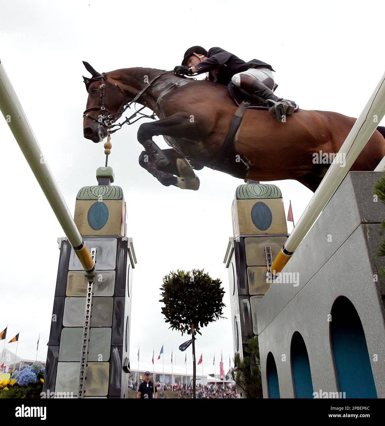 British rider Michael Whitaker on Suncal Portofino clears an obstacle ...