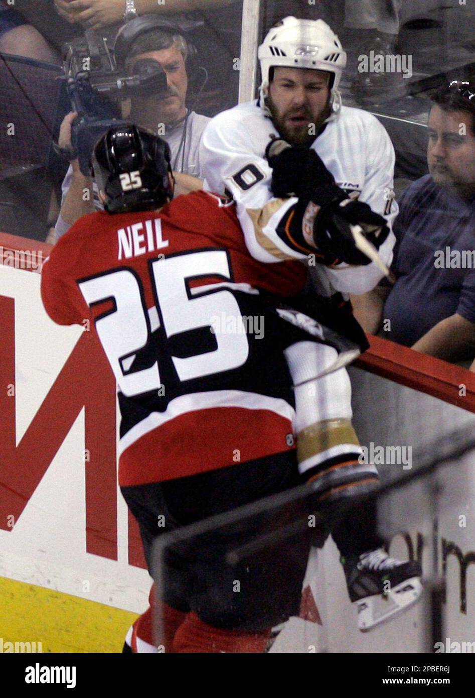 Ottawa Senators right wing Chris Neil (25) checks Anaheim Ducks ...