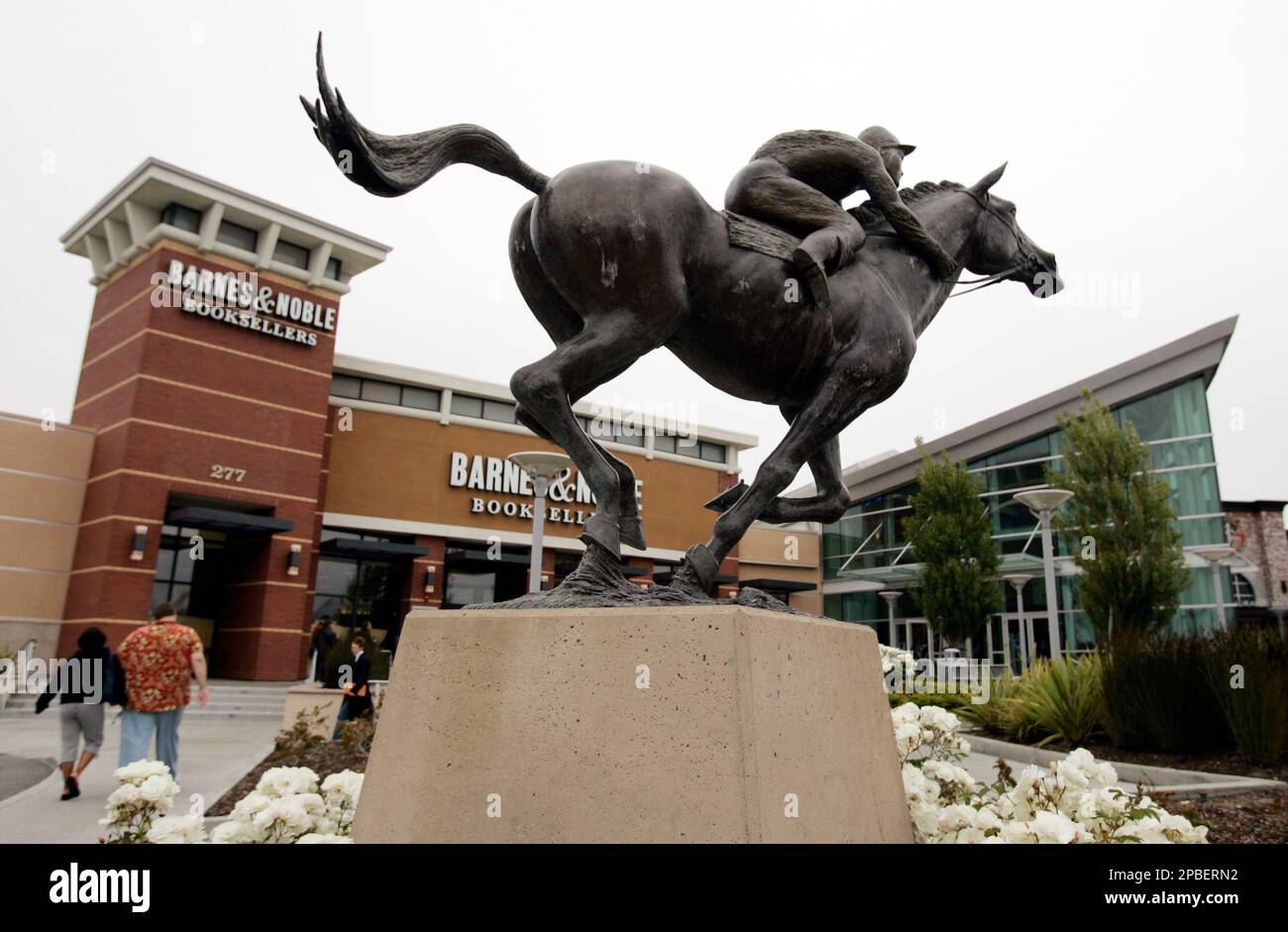 A statue of a horse and jockey racing is displayed at The Shops at ...