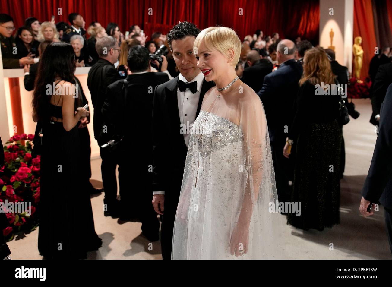 Thomas Kail, left, and Michelle Williams arrive at the Oscars on Sunday ...
