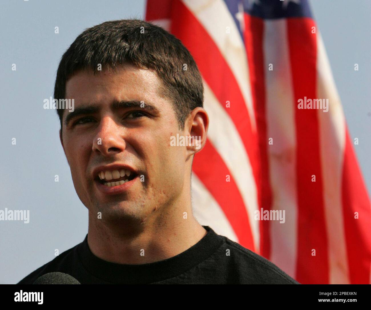 Marine Corps veteran Liam Madden speaks with reporters during a news ...