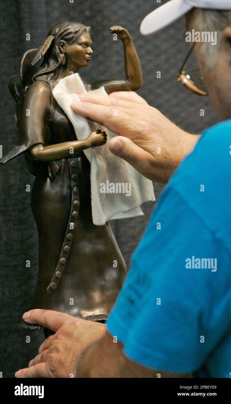 Dick Albro, of Bartlesville, Okla., polishes a piece of art work ...
