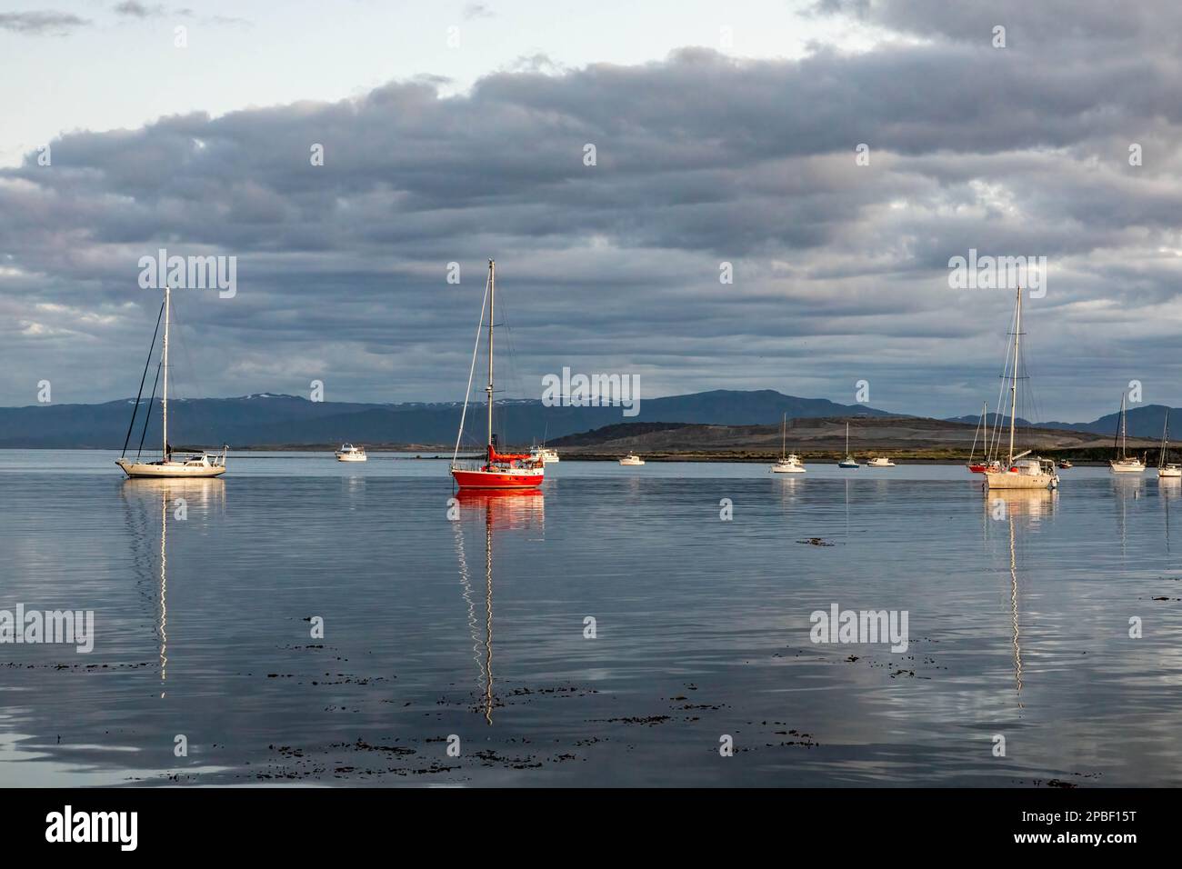 Boats floating in the port of Ushuaia Argentina at sunset in the Beagle ...