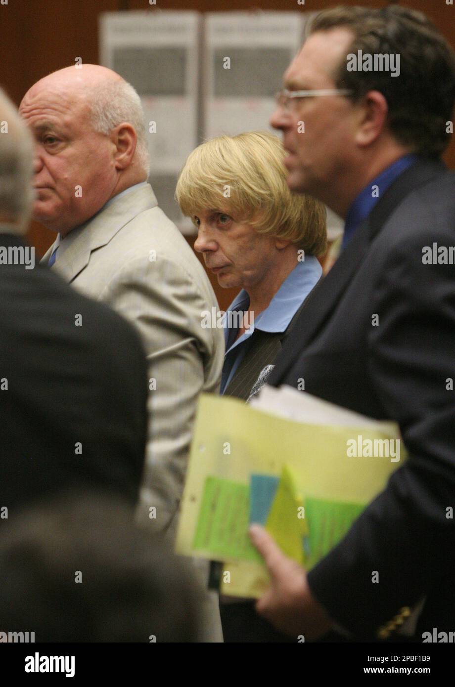 Music producer Phil Spector is flanked by defense team members Bruce ...