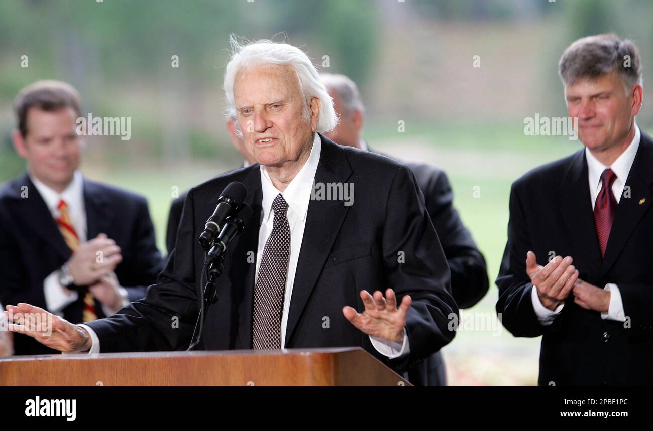 Billy Graham speaks as his son Franklin Graham, right, listens during a ...