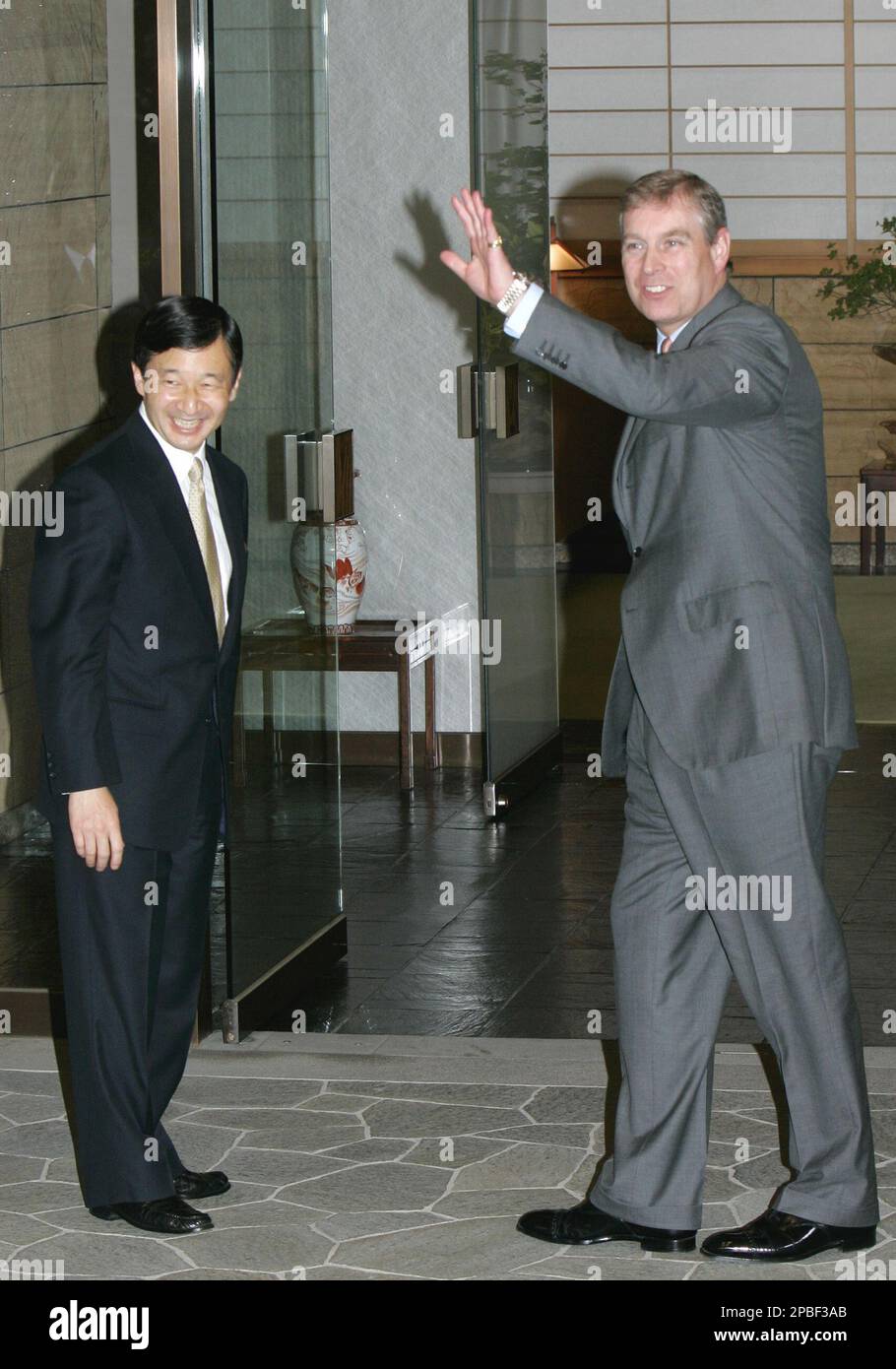 Britain's Prince Andrew, right, waves as he is greeted by Japan's Crown ...