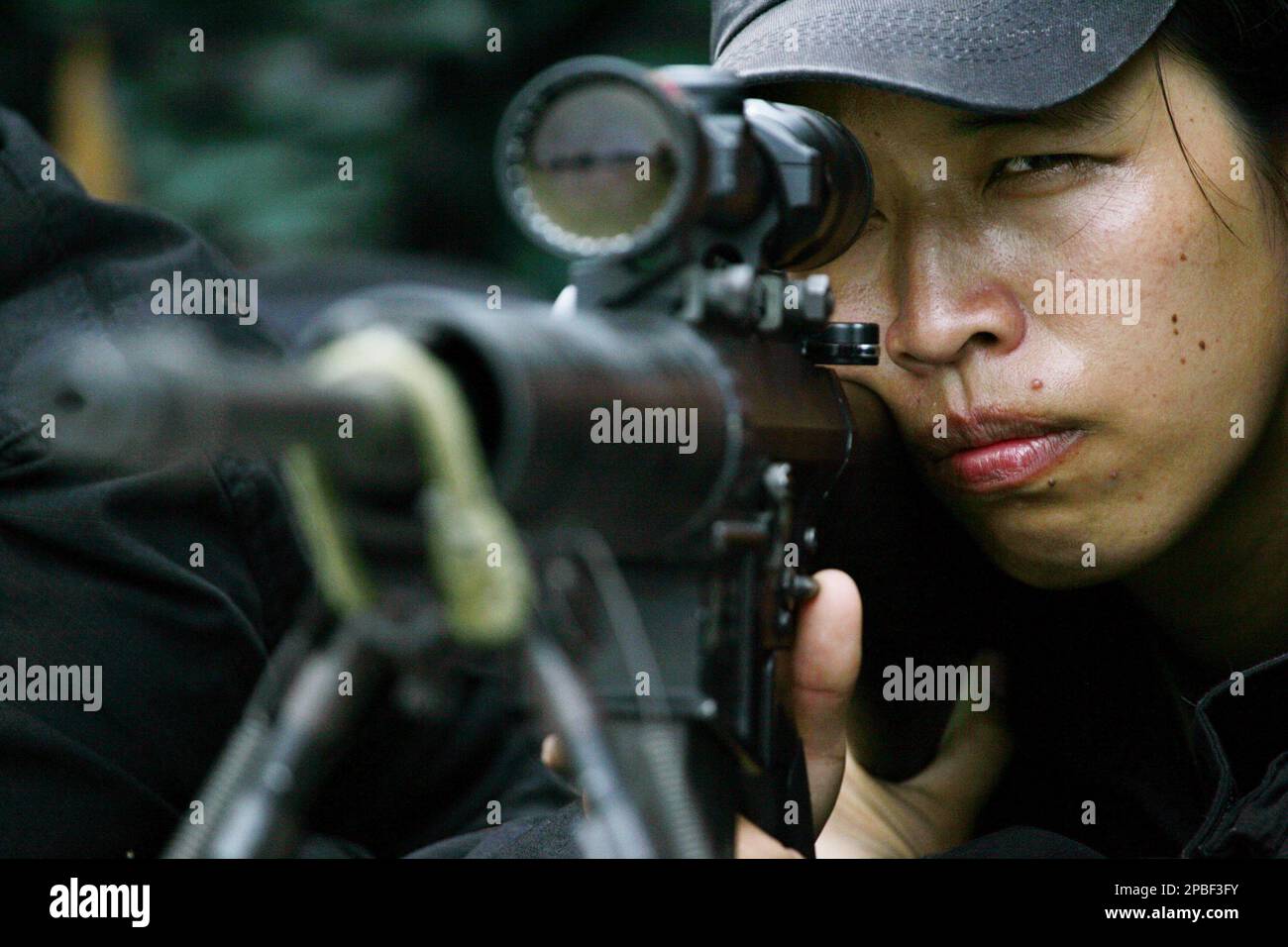 A Philippine female sniper of the Special Action Force demonstrates her ...