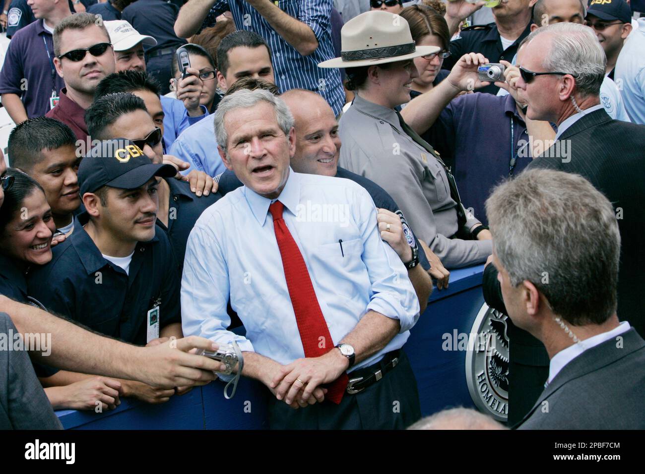 President Bush poses with Customs and Border Patrol personnel after he ...